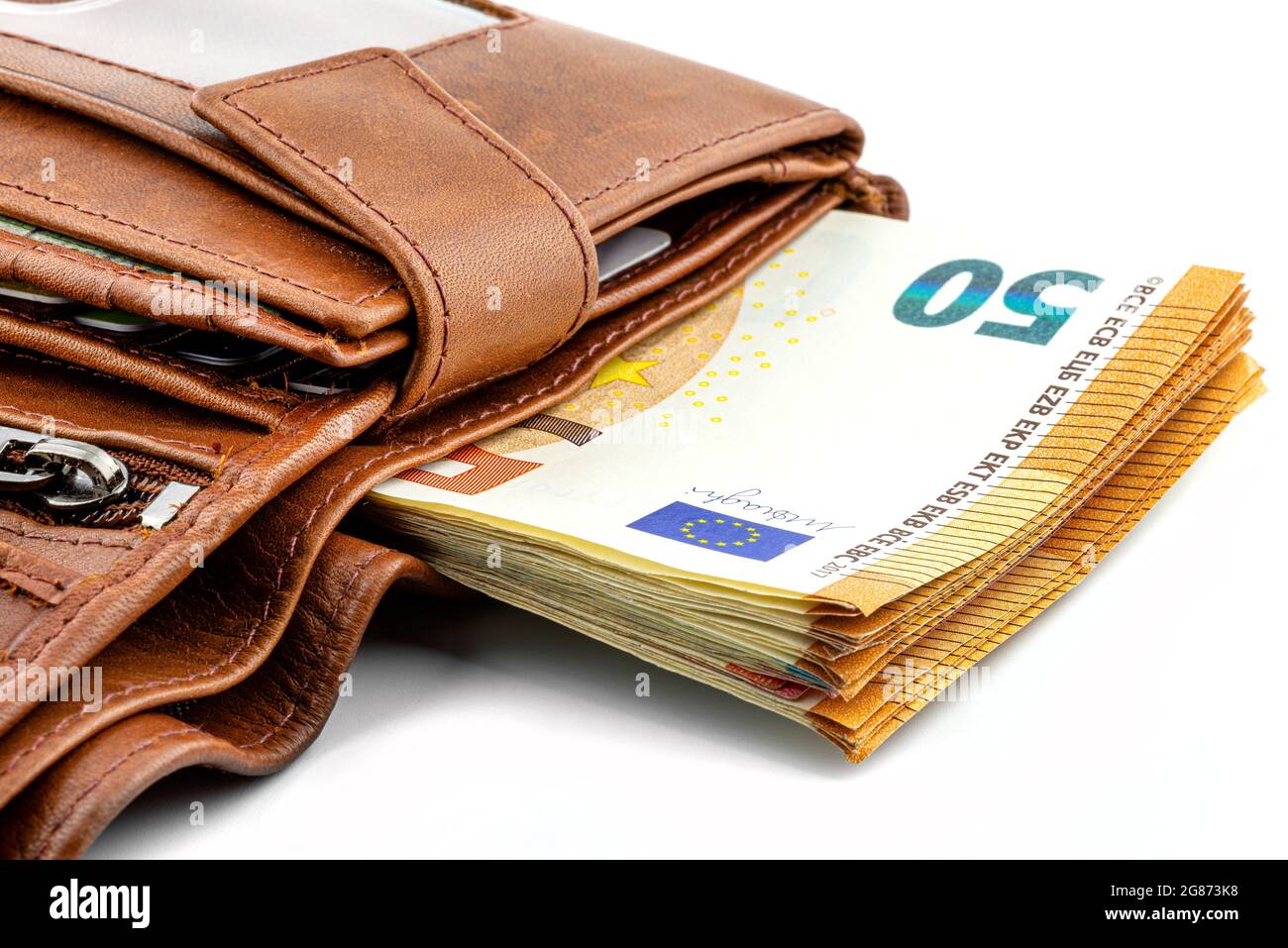A macro shot of a brown mens leather wallet with a stack of Euro ...