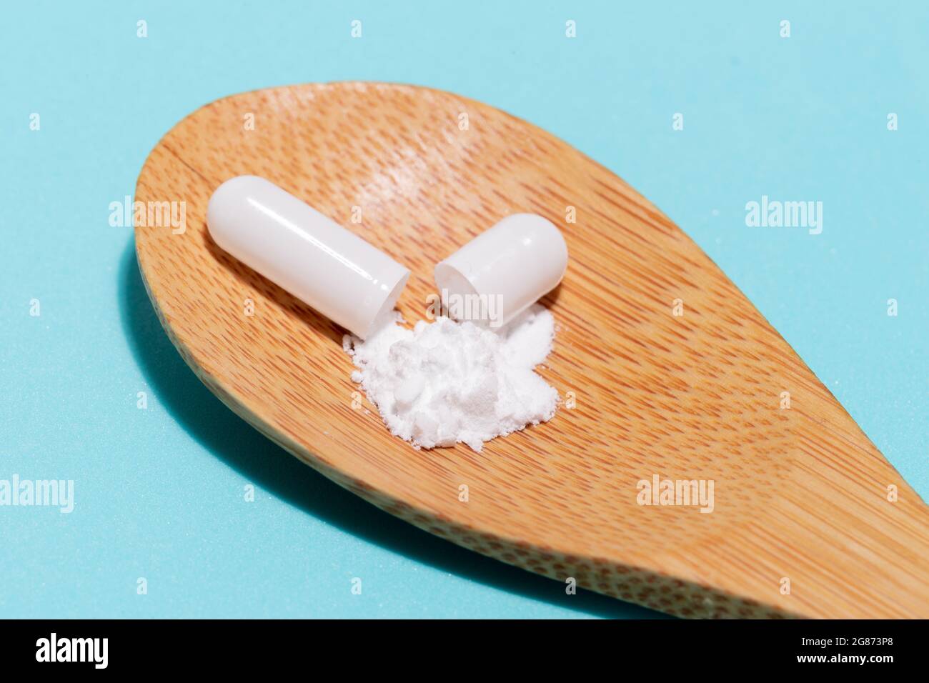 open pill with powder in a wooden spoon. photo with a copy-space Stock ...
