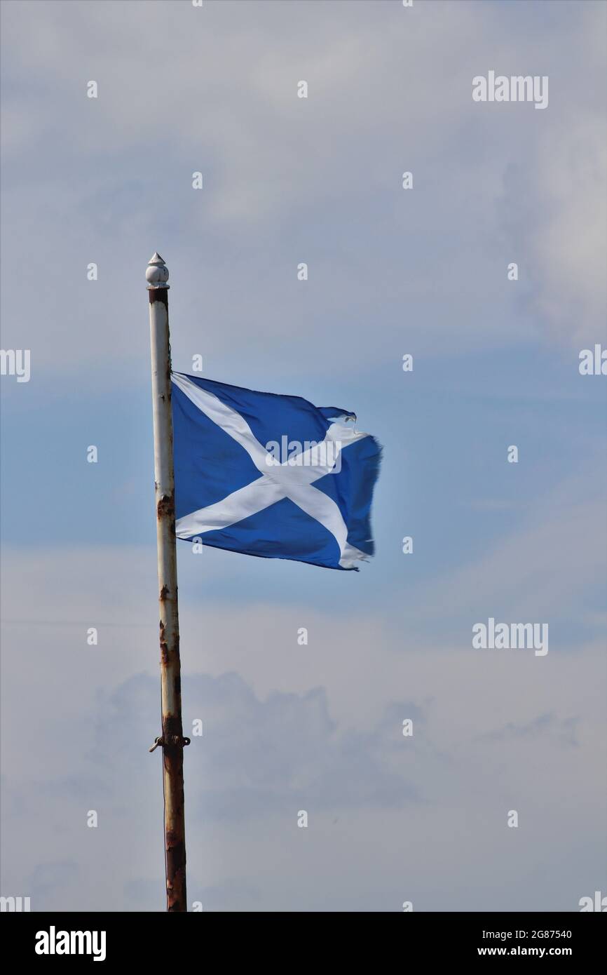 Tattered Scottish flag on rusty flagpole Stock Photo - Alamy