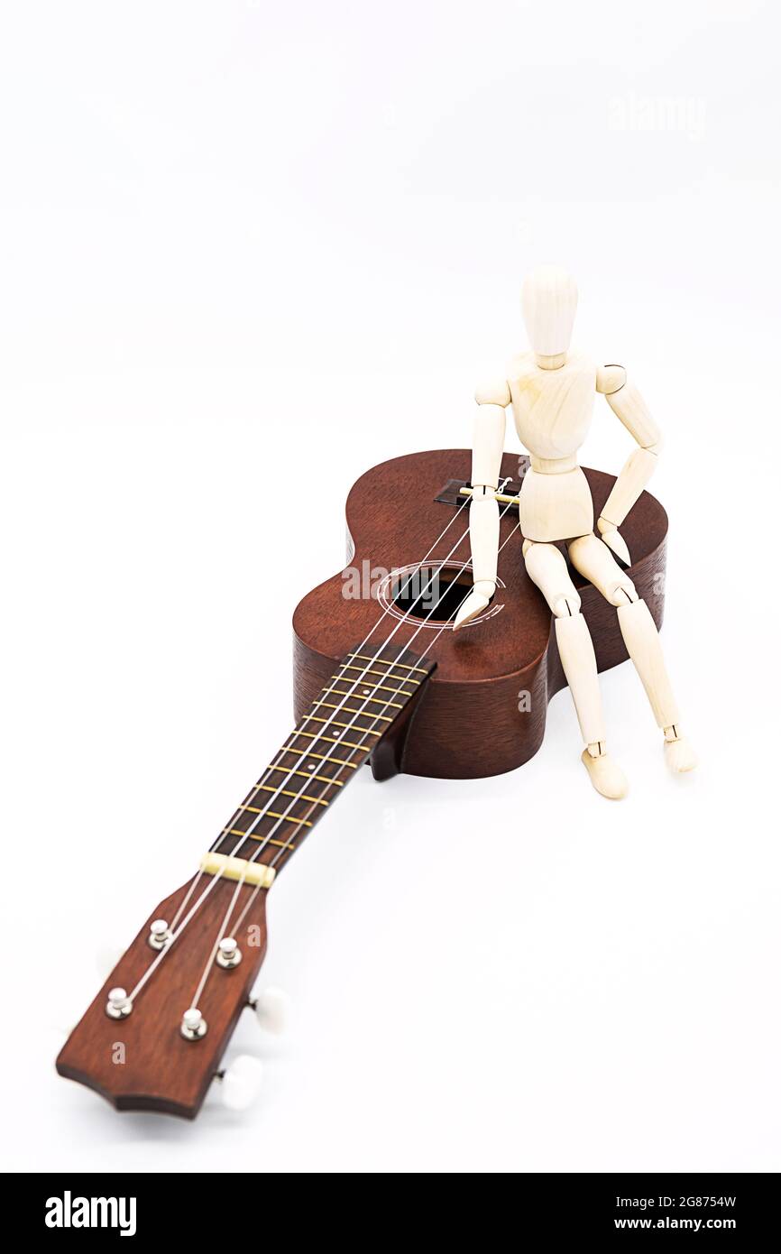 Ukulele acoustic guitar with human mannequin figure . Break time for ...