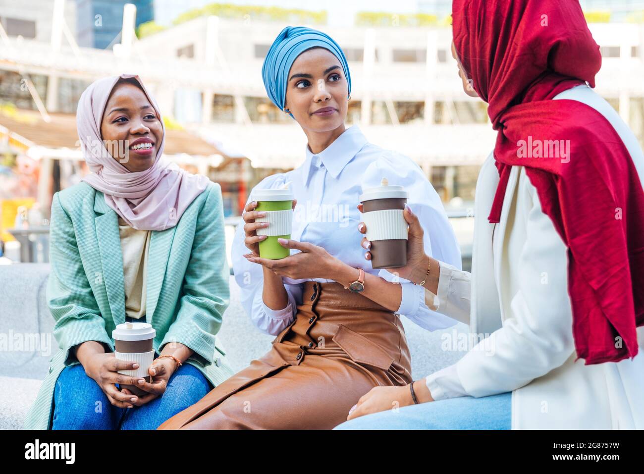 Multiethnic group of muslim girls wearing casual clothes and ...