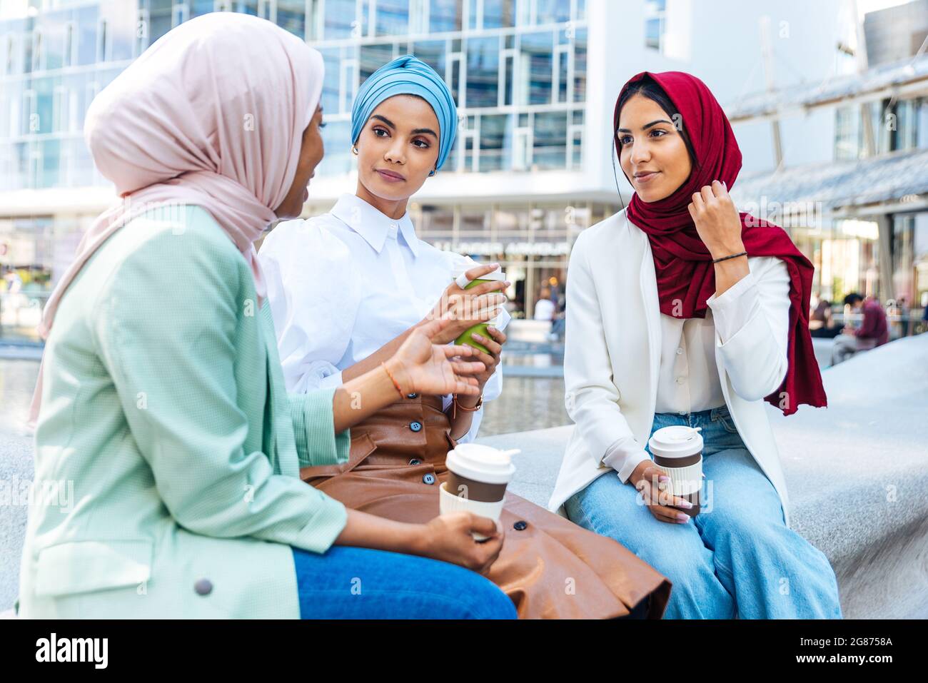 Multiethnic group of muslim girls wearing casual clothes and ...