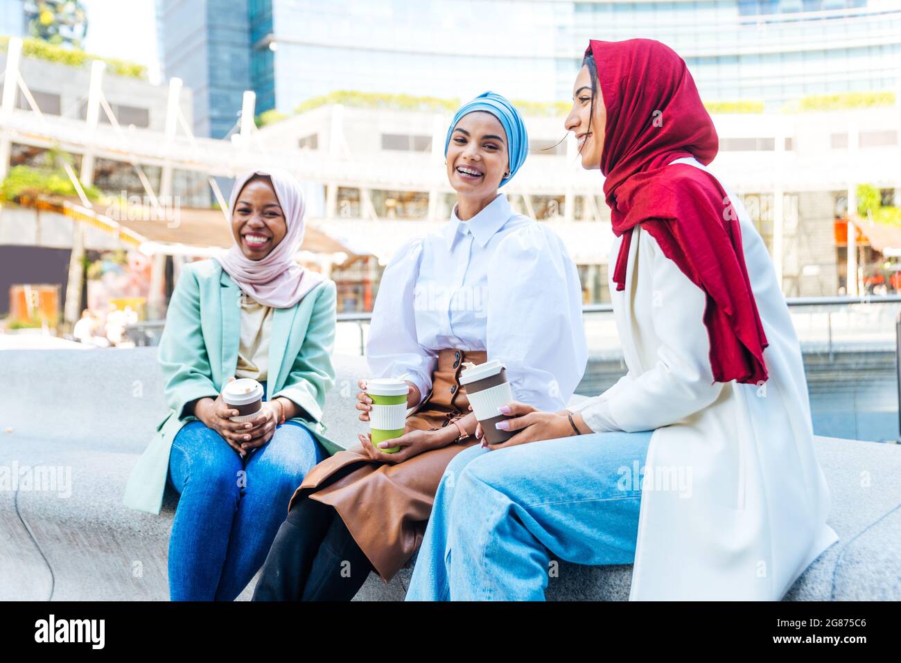 Multiethnic group of muslim girls wearing casual clothes and ...