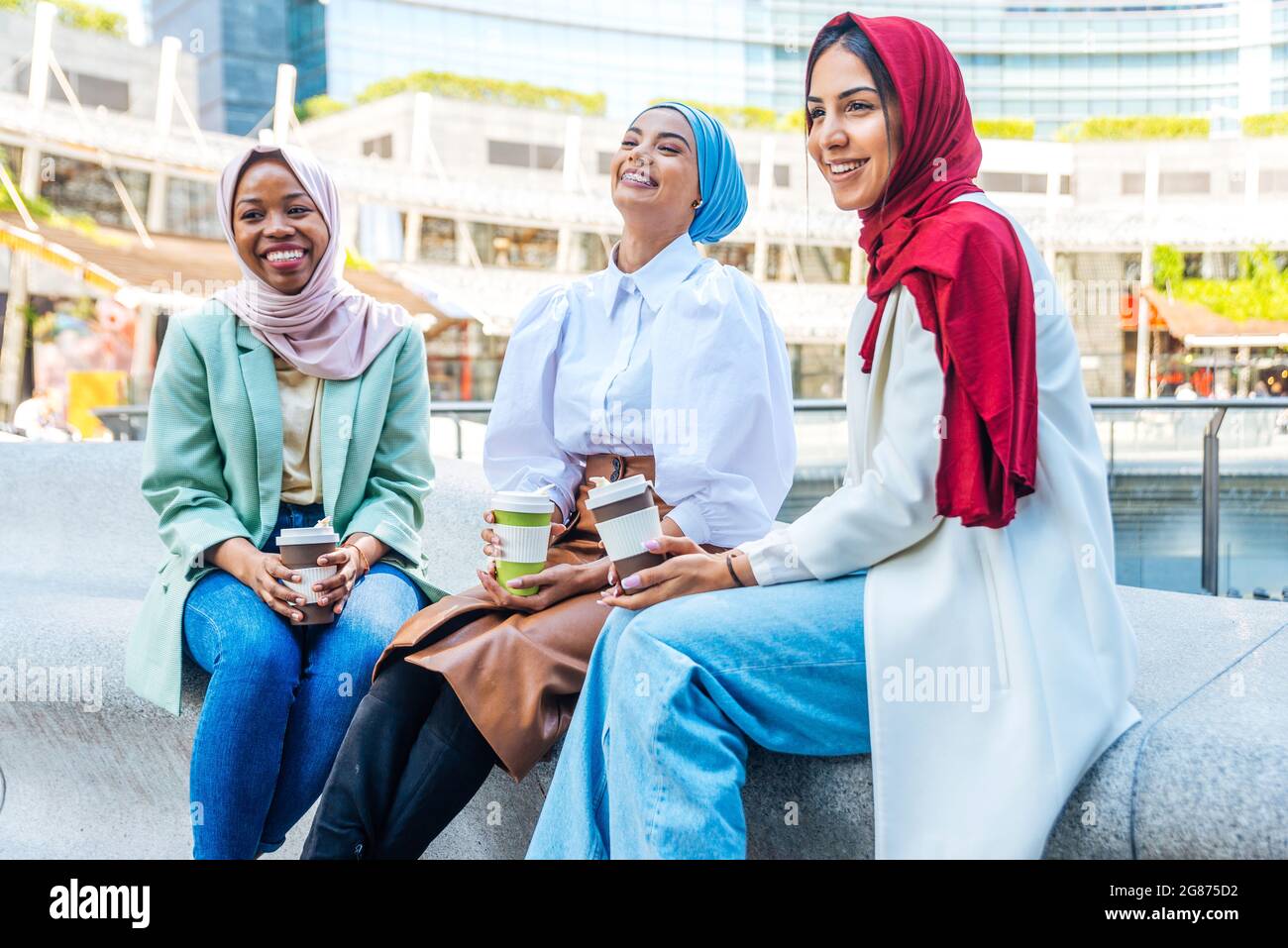 Multiethnic group of muslim girls wearing casual clothes and ...