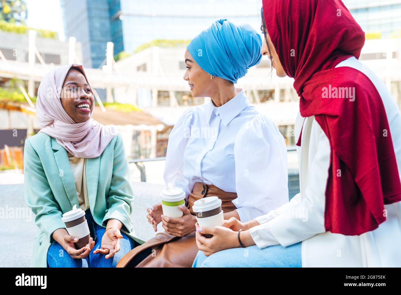 Multiethnic group of muslim girls wearing casual clothes and ...