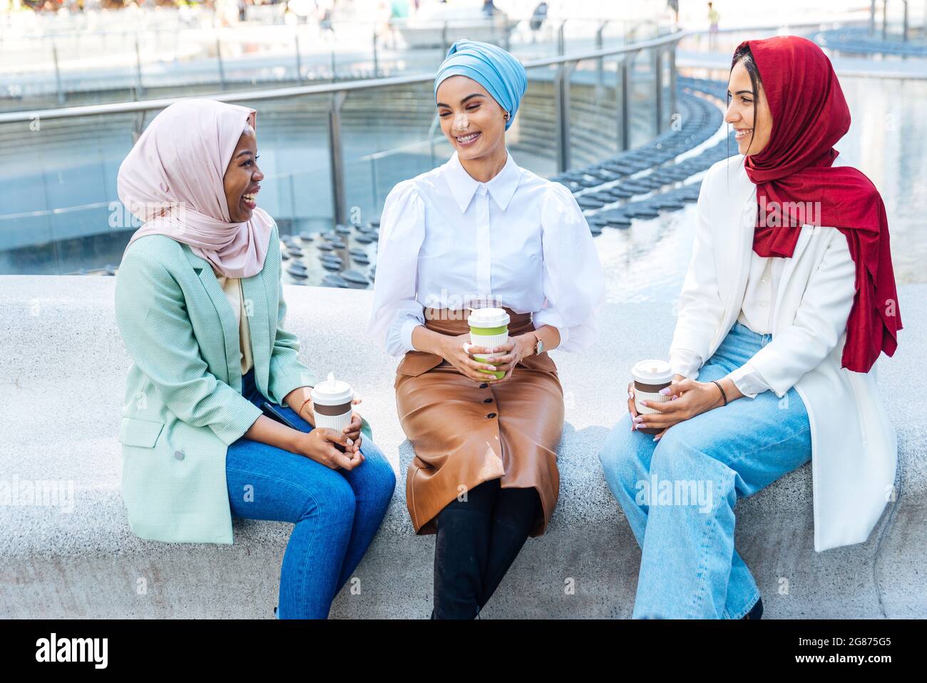 Multiethnic group of muslim girls wearing casual clothes and ...