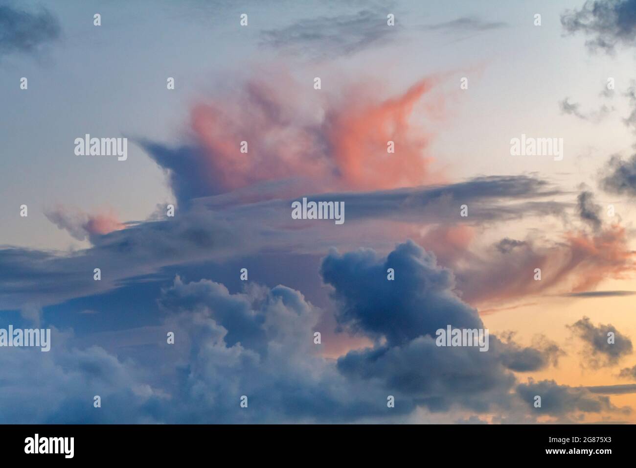 The setting sun lighting up the cloud with a pinkish colour Stock Photo ...