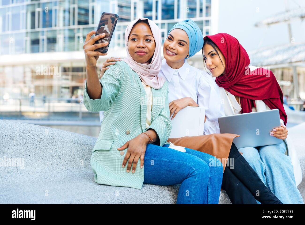 Multiethnic group of muslim girls wearing casual clothes and ...