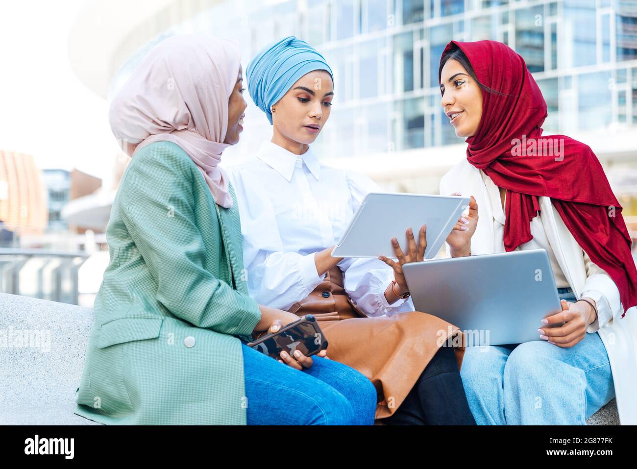 Multiethnic group of muslim girls wearing casual clothes and ...