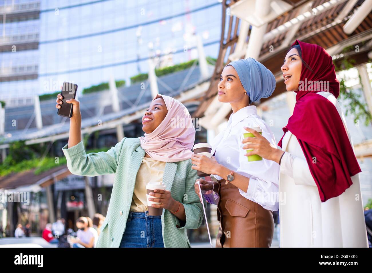 Multiethnic group of muslim girls wearing casual clothes and ...