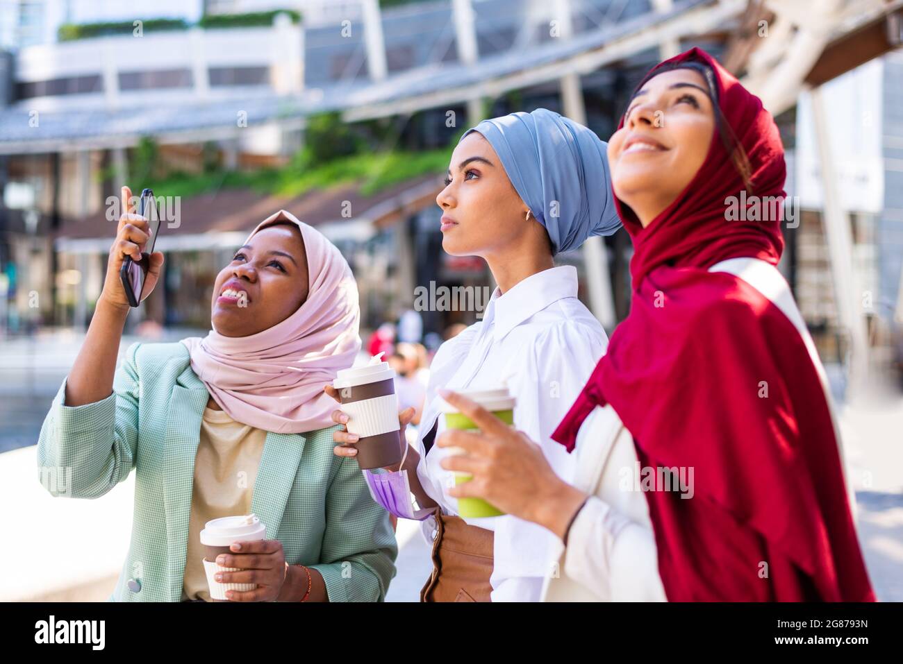 Multiethnic group of muslim girls wearing casual clothes and ...