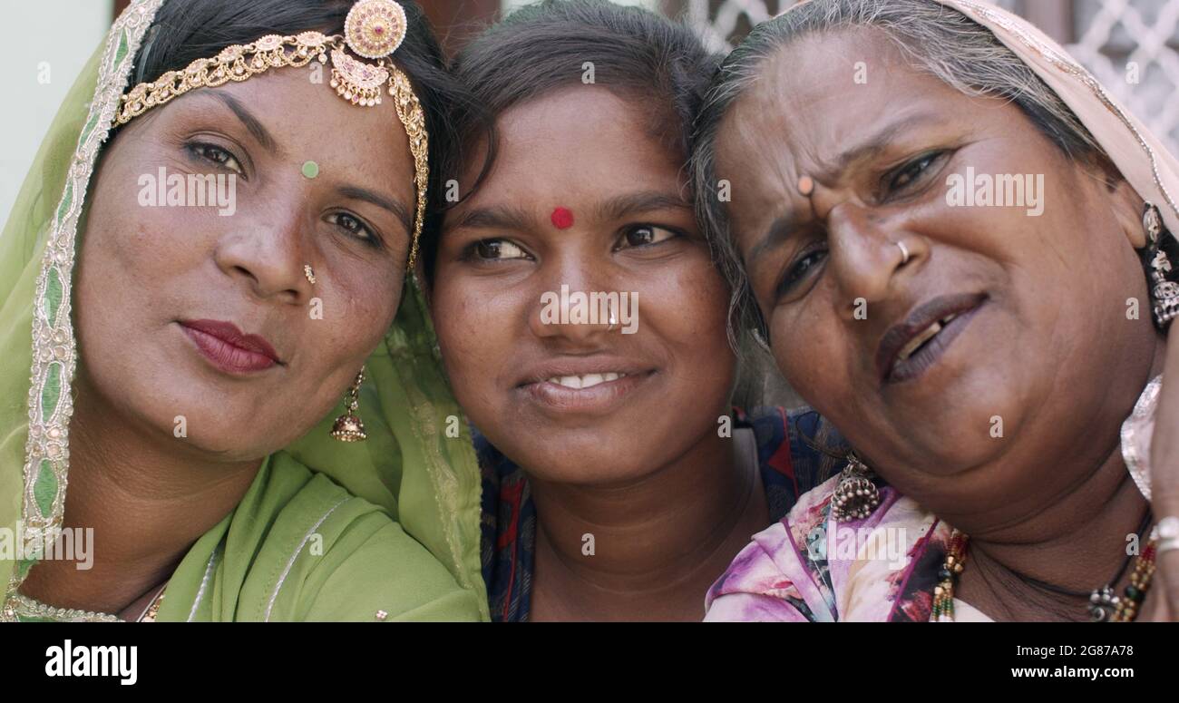 Three generations of South Asian women in traditional clothing posing ...