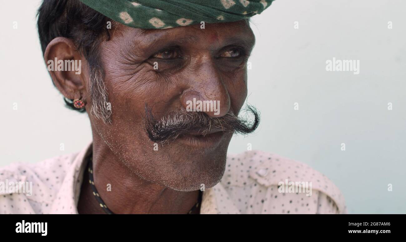 Closeup portrait of a senior South Asian male in traditional clothing ...
