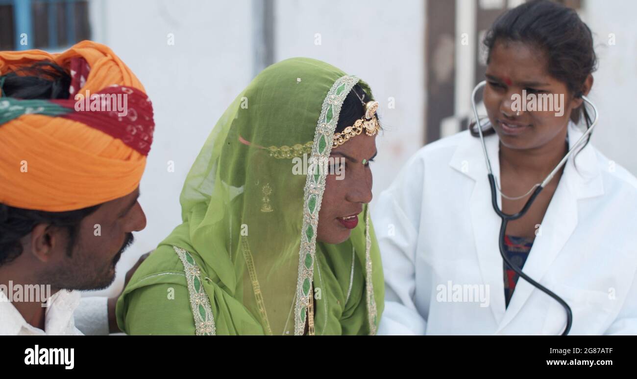 Female doctor is examining patients; Indian people in traditional ...