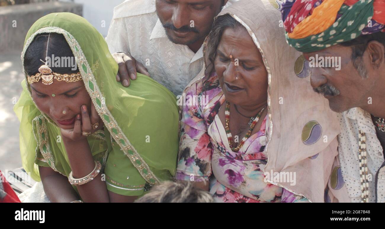 Group of Indian people in traditional attire is carefully watching ...