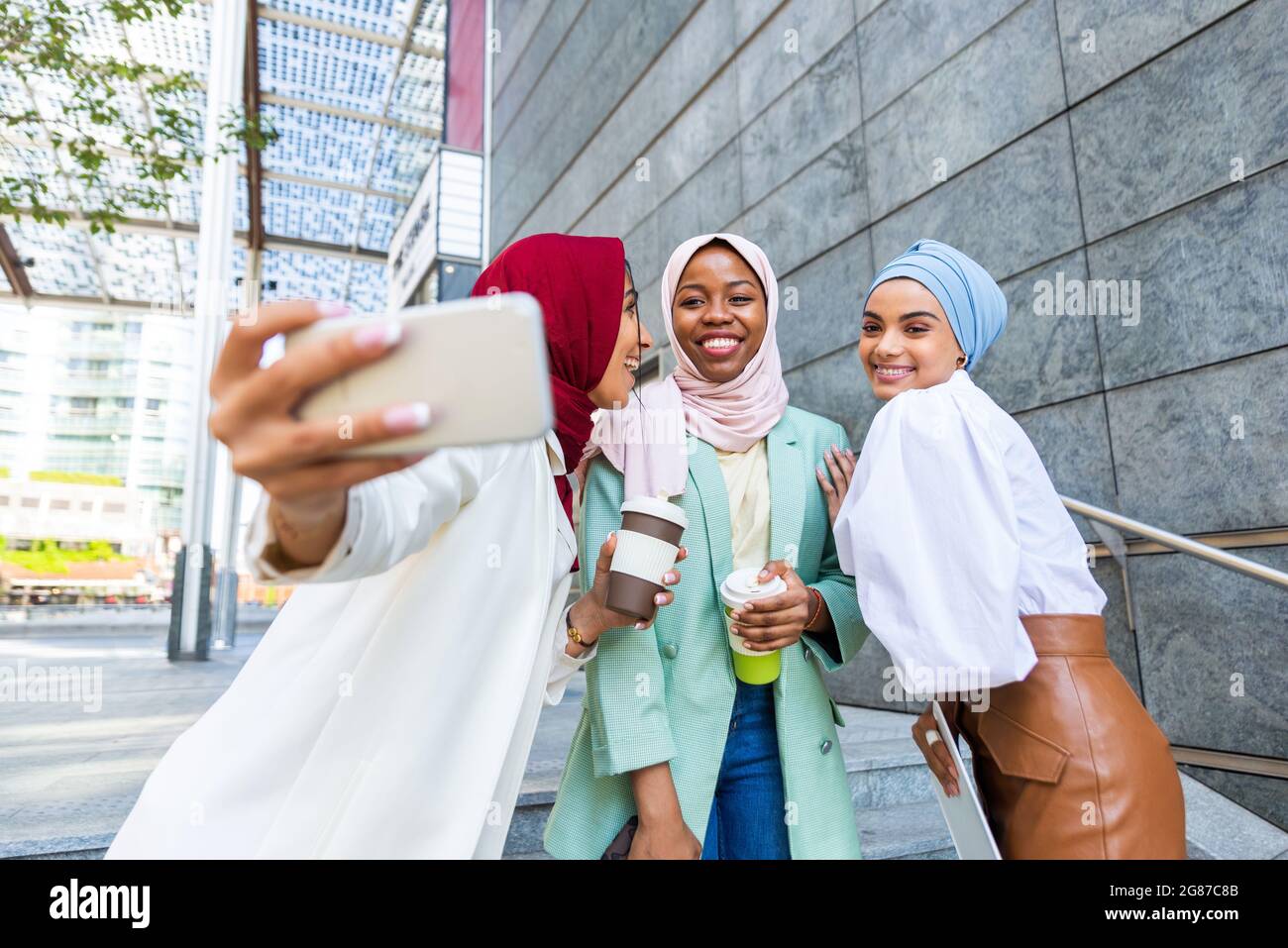 Multiethnic group of muslim girls wearing casual clothes and ...