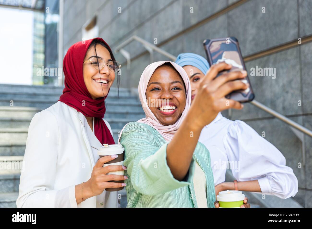 Multiethnic group of muslim girls wearing casual clothes and ...