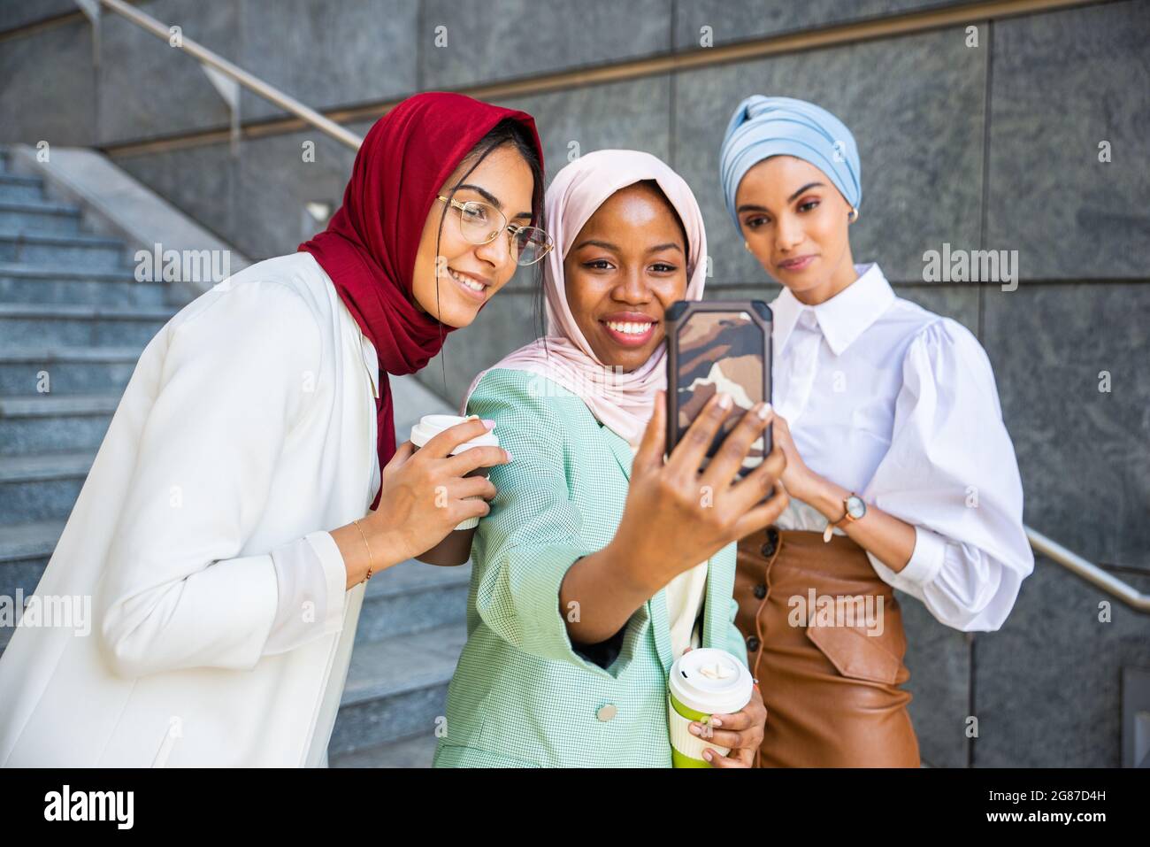 Multiethnic group of muslim girls wearing casual clothes and ...