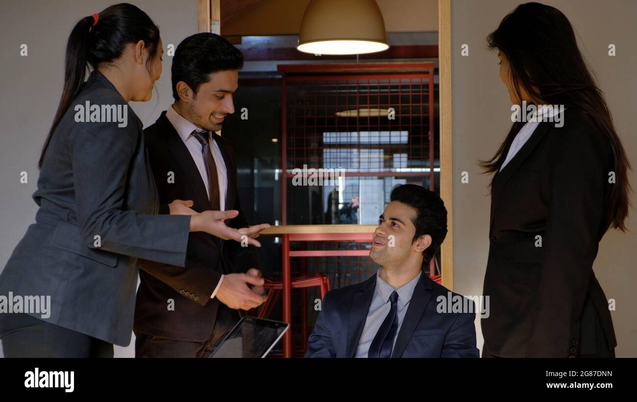 Group of young Indian business partners having a discussion in the ...