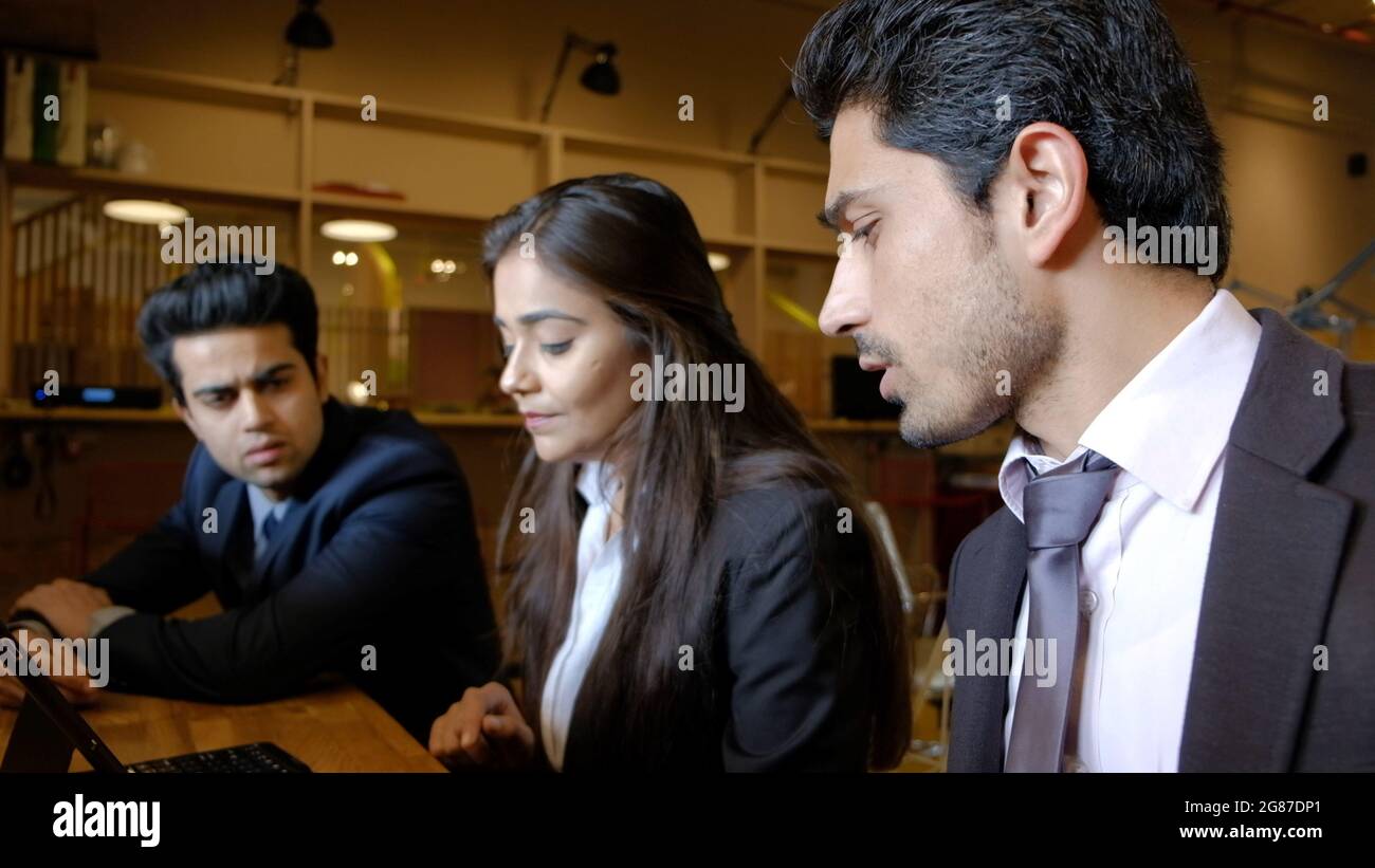 Group of young Indian business partners having a discussion in the ...