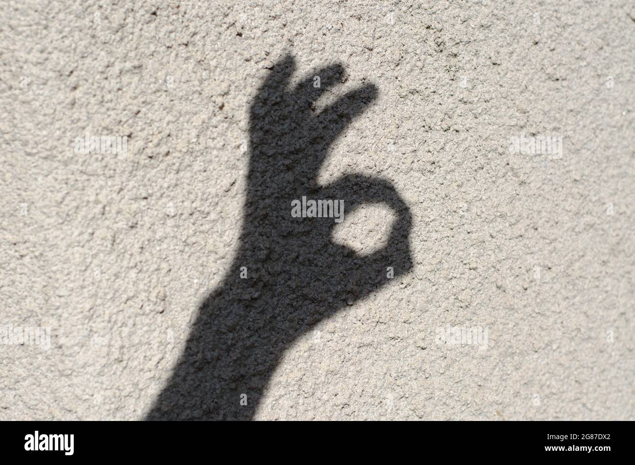 The shadow of a man's hand on the wall shows an okay gesture Stock ...