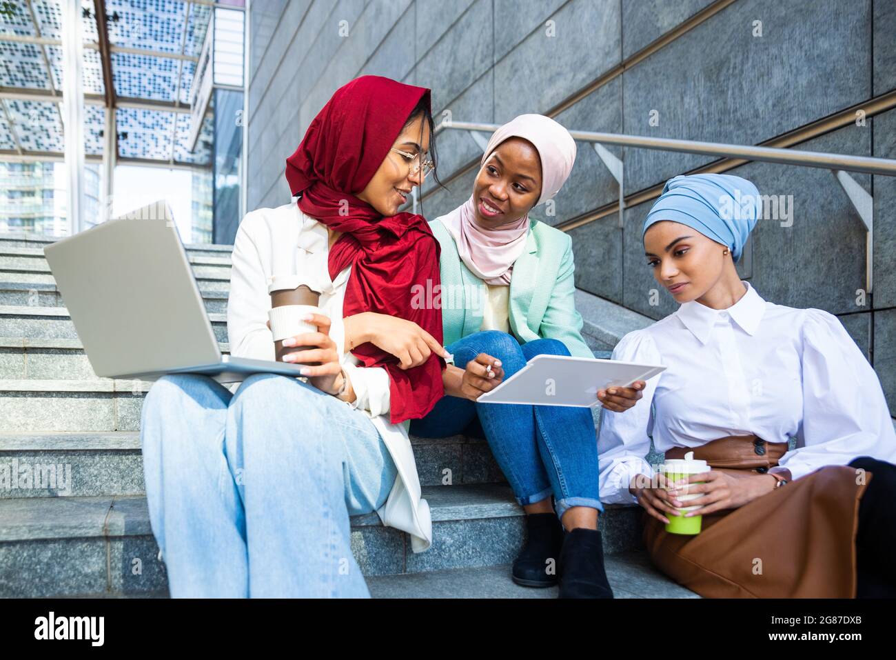 Multiethnic group of muslim girls wearing casual clothes and ...