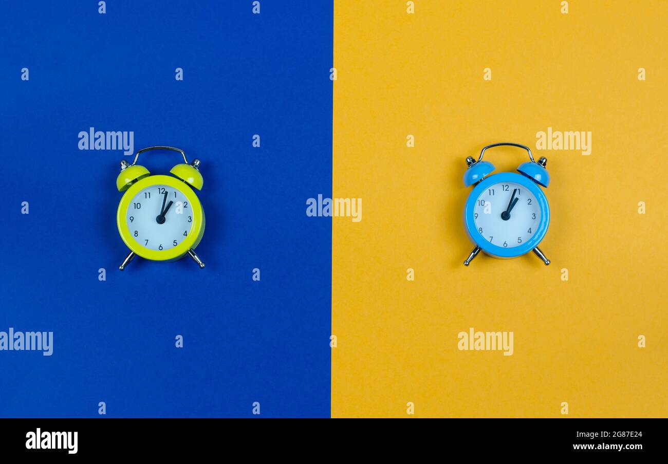 Clock on a yellow-blue background. Yellow clock on a blue background ...