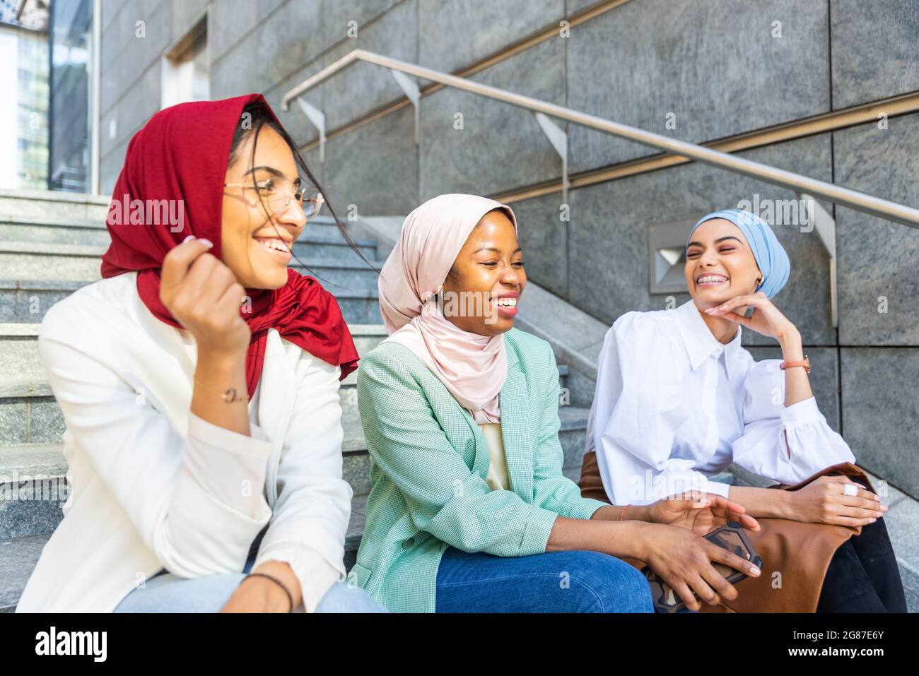 Multiethnic group of muslim girls wearing casual clothes and ...