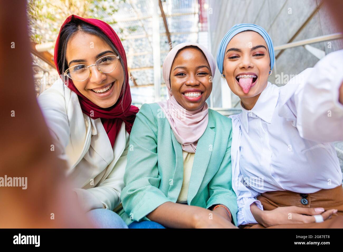 Multiethnic group of muslim girls wearing casual clothes and ...