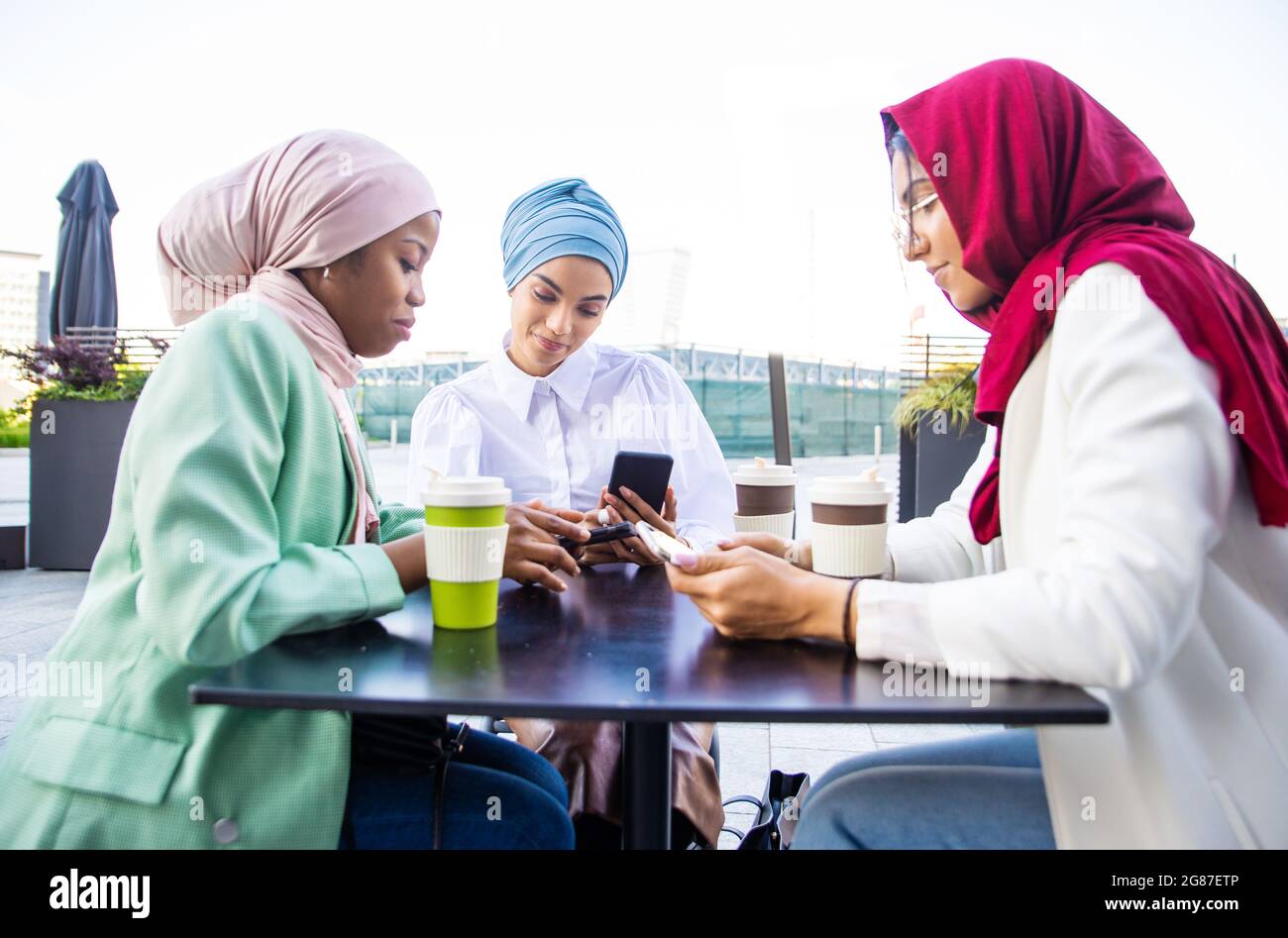 Multiethnic group of muslim girls wearing casual clothes and ...
