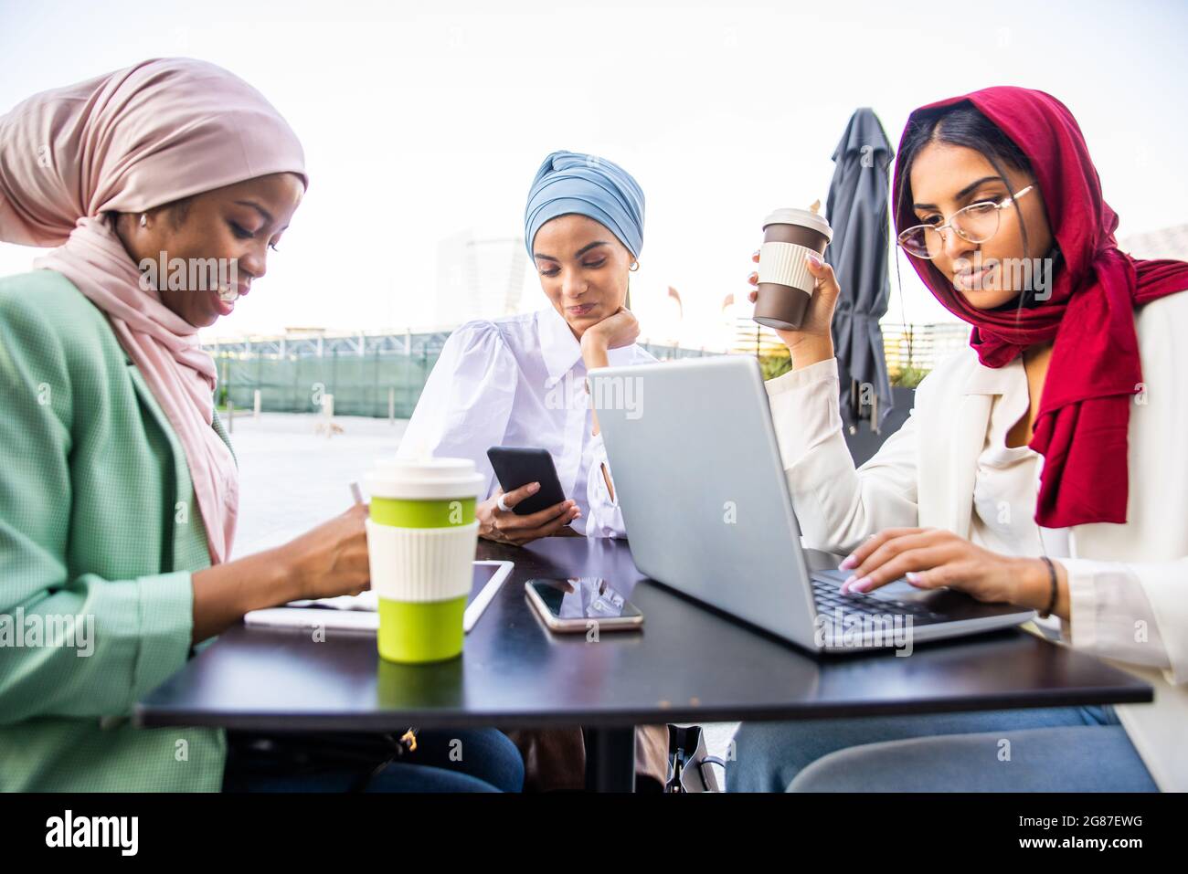 Multiethnic group of muslim girls wearing casual clothes and ...