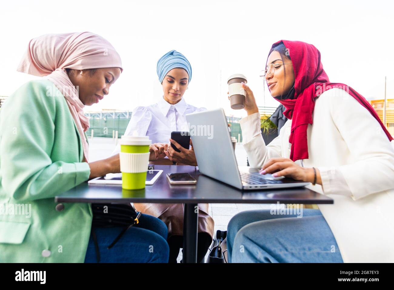 Multiethnic group of muslim girls wearing casual clothes and ...