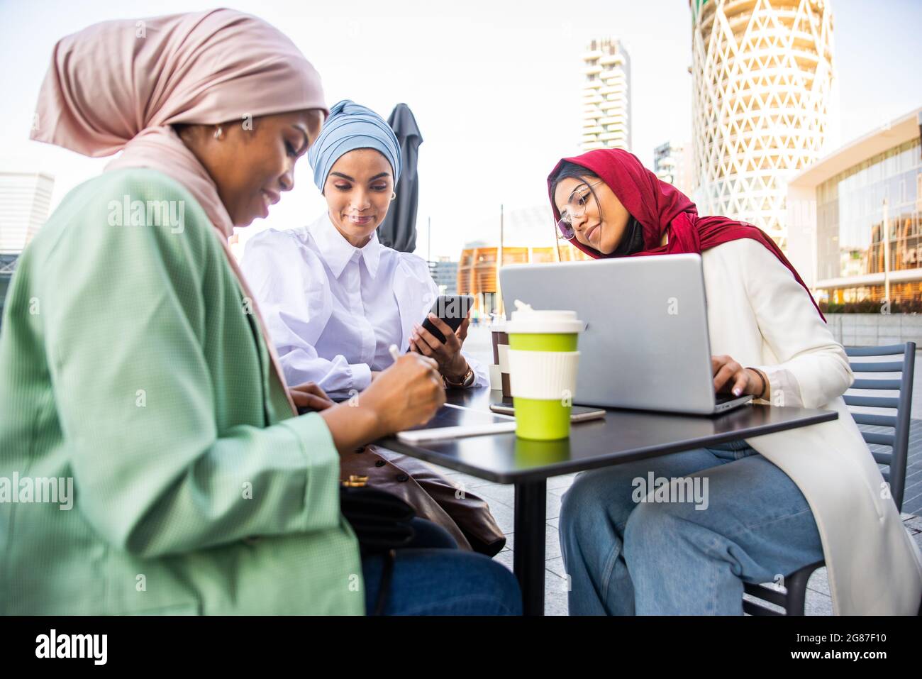 Multiethnic group of muslim girls wearing casual clothes and ...