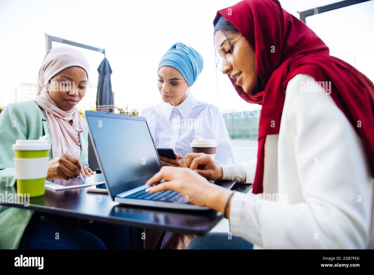 Multiethnic group of muslim girls wearing casual clothes and ...
