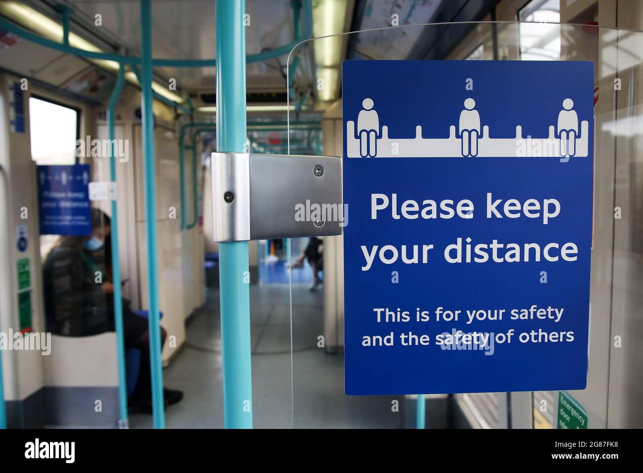 A 'Keep your distance' sign on the Dockland Light Railway Stock Photo ...