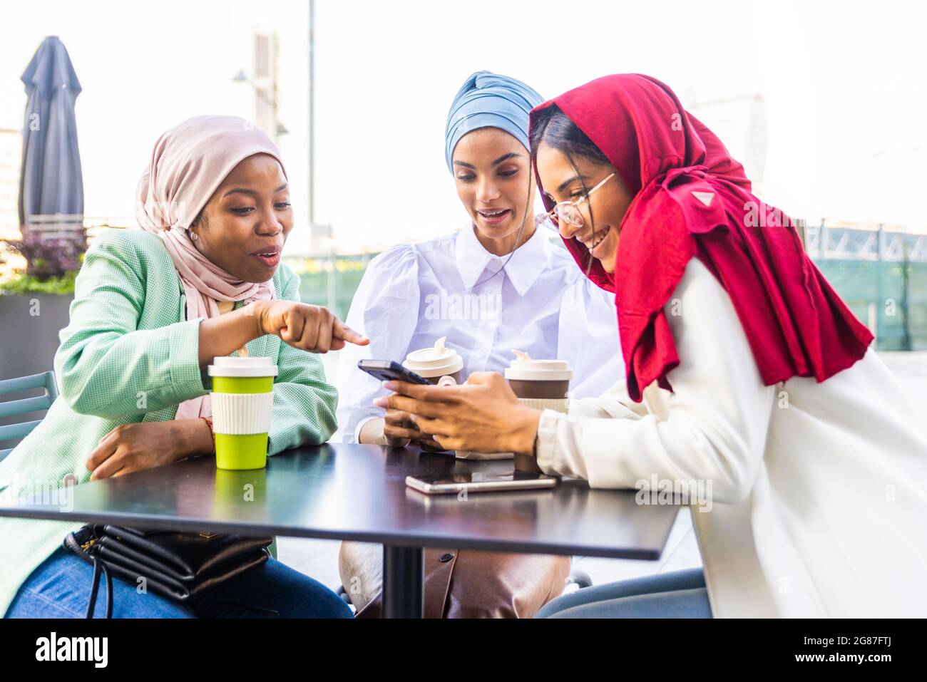 Multiethnic group of muslim girls wearing casual clothes and ...