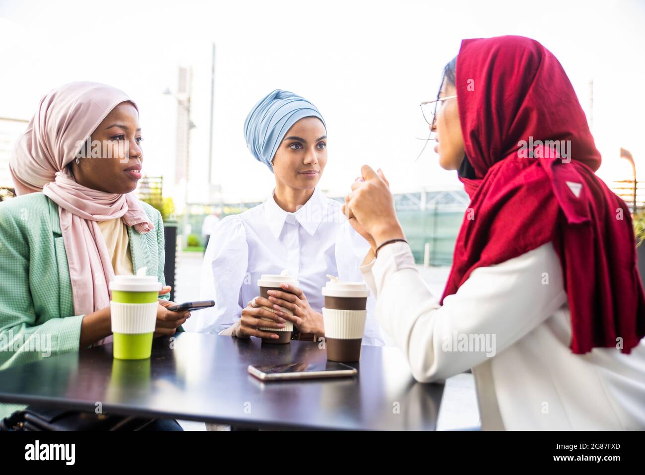 Multiethnic group of muslim girls wearing casual clothes and ...