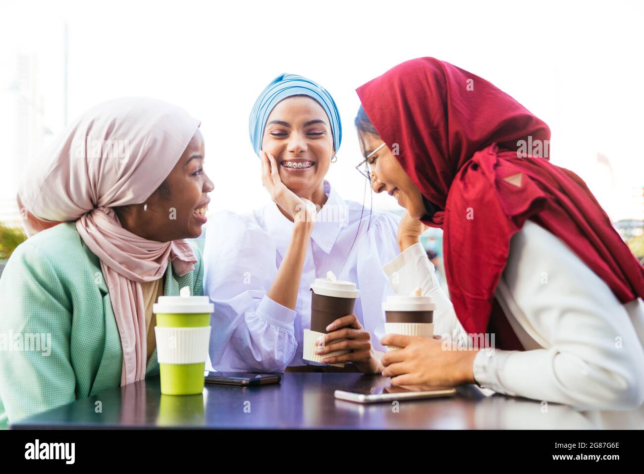 Multiethnic group of muslim girls wearing casual clothes and ...