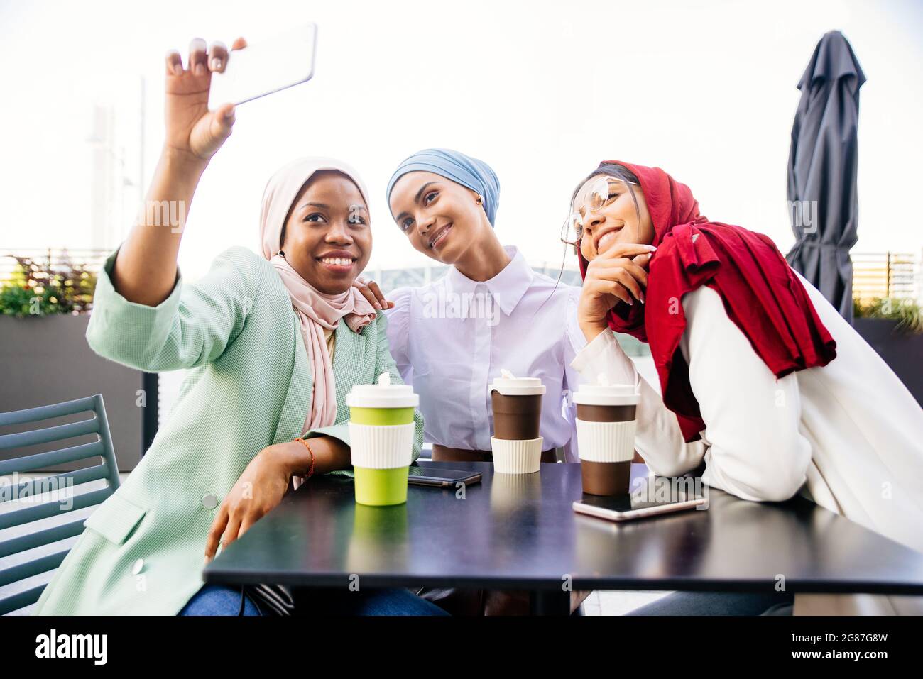 Multiethnic group of muslim girls wearing casual clothes and ...