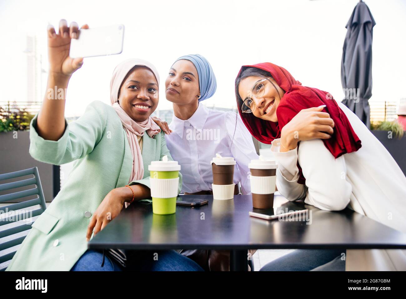 Multiethnic group of muslim girls wearing casual clothes and ...