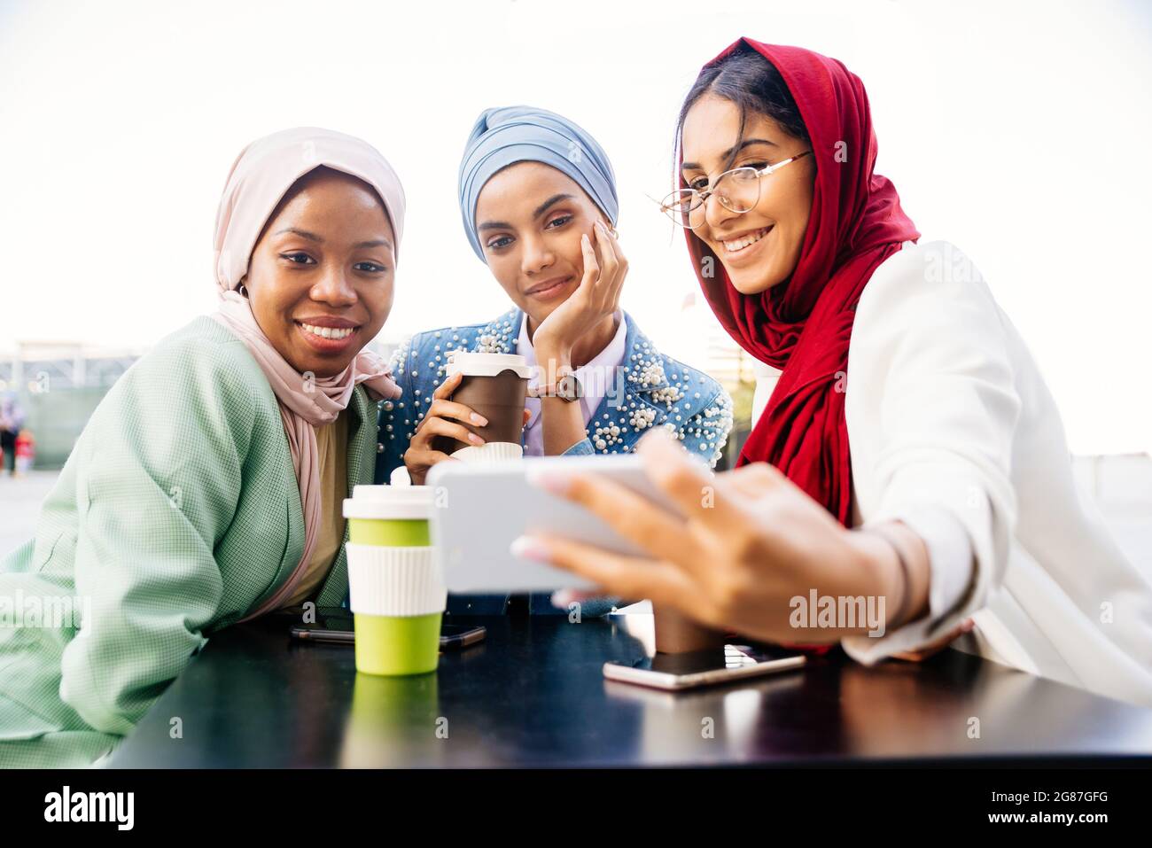 Multiethnic group of muslim girls wearing casual clothes and ...