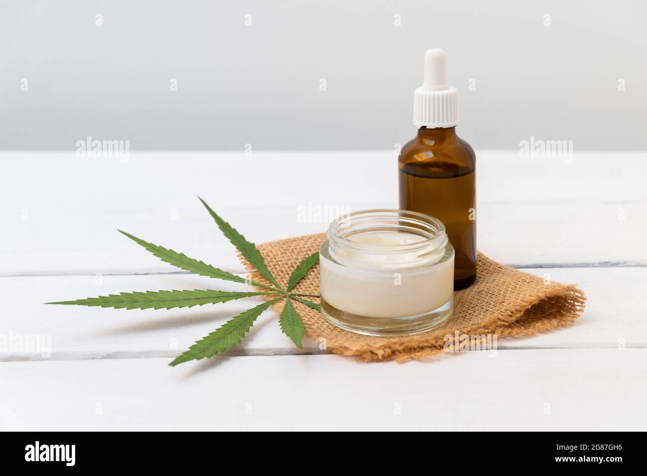 Cannabis infused cosmetics concept. CBD cream and hemp oil on white ...