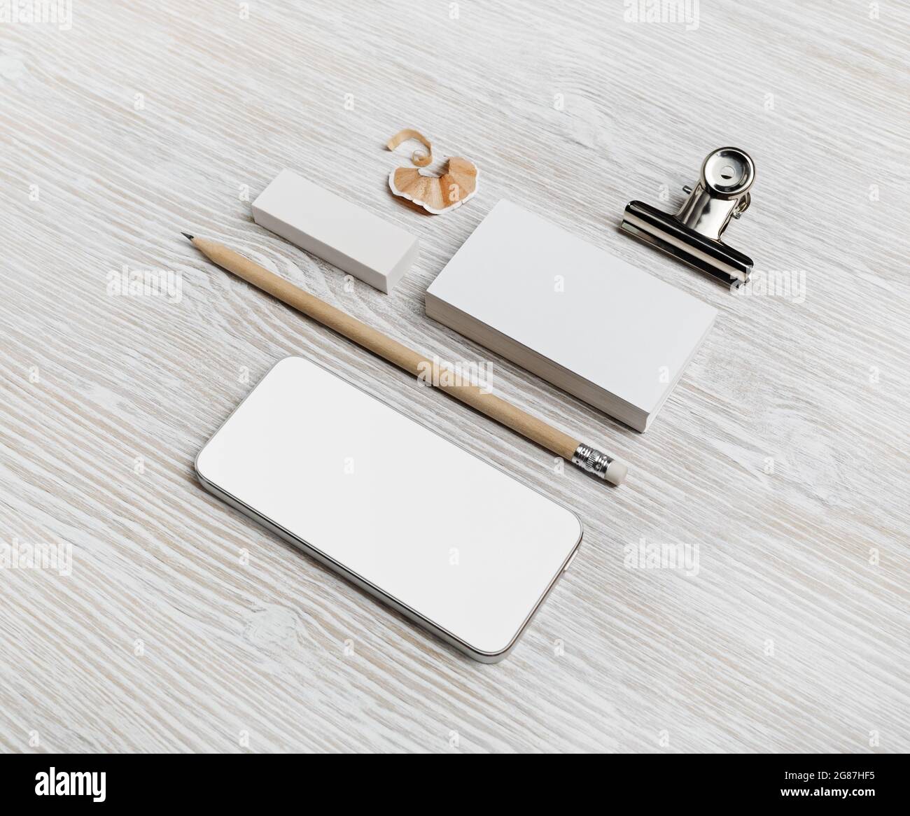 Smartphone and stationery on light wooden background. Blank business ...