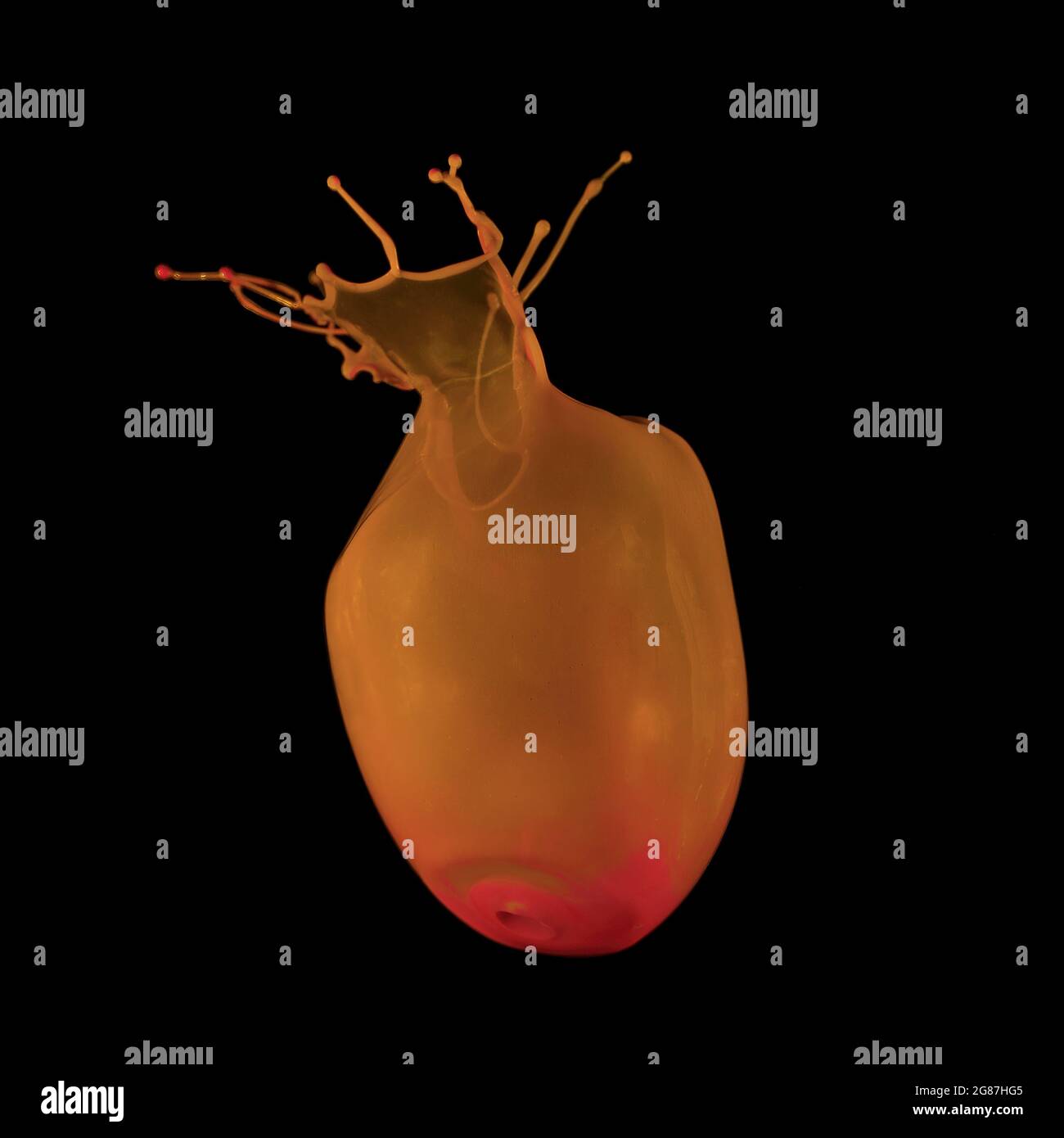 An orange container vessel shape water formed by water drops shot from ...