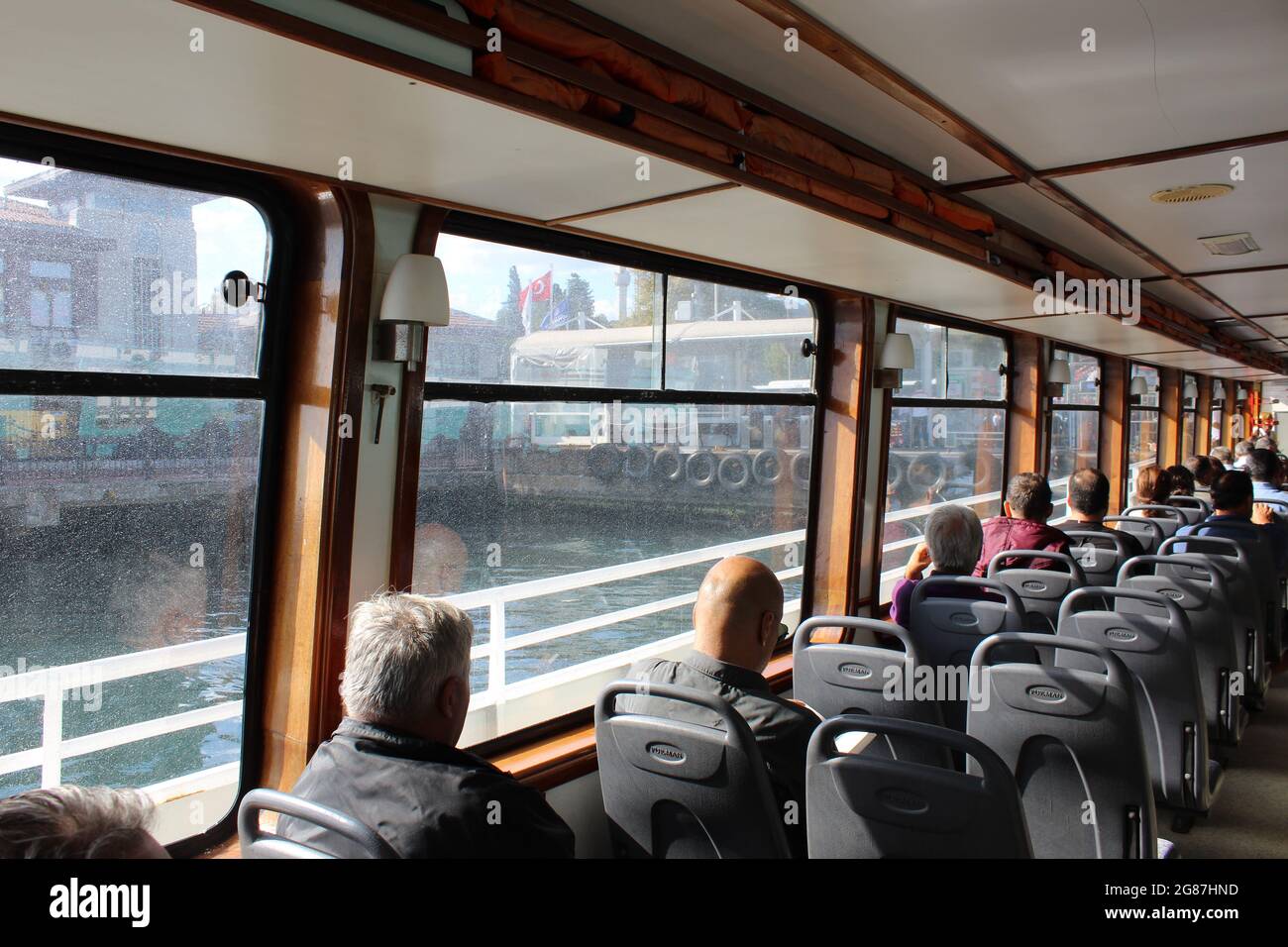 Inside of a ferry-boat in Istanbul with passengers sitting. 2019 Stock ...