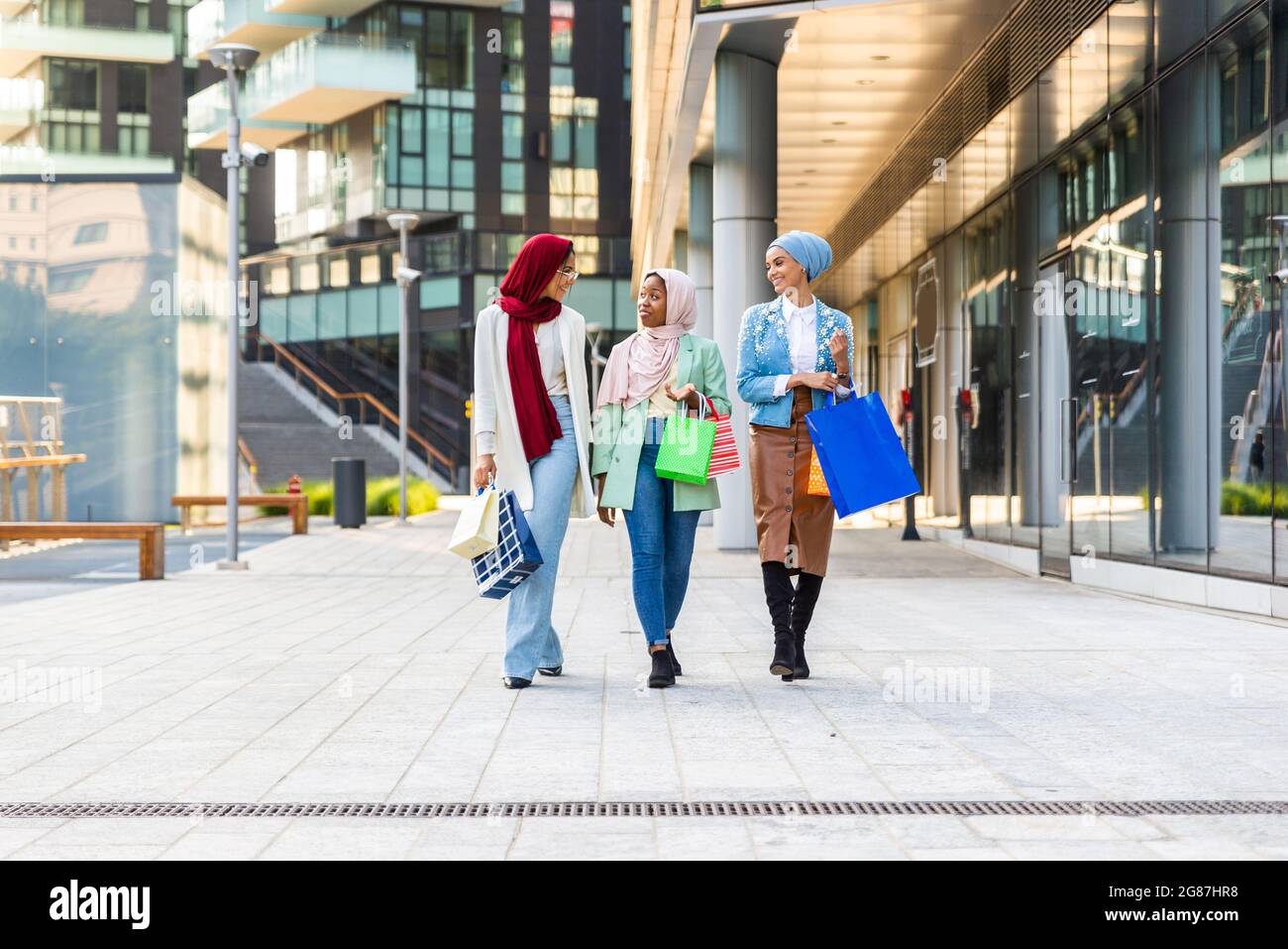 Multiethnic group of muslim girls wearing casual clothes and ...