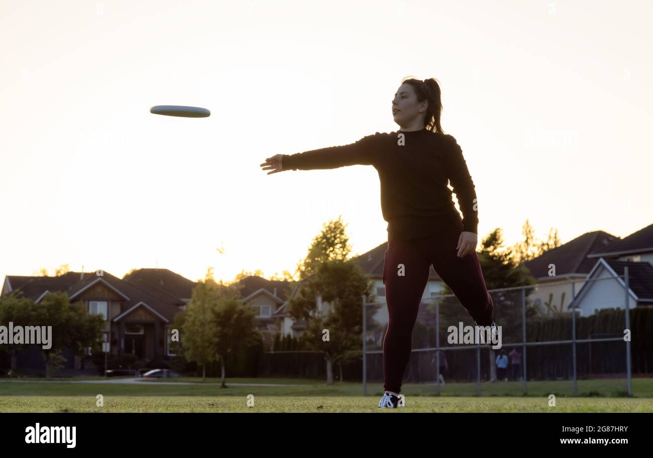 White Caucasian Adult Girl Playing Frisbee in the Green Field Stock ...