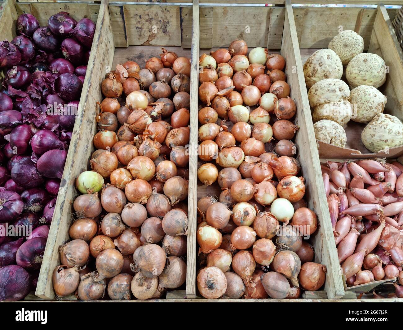 UK farm shop display showing a variety of onions and other vegetables ...