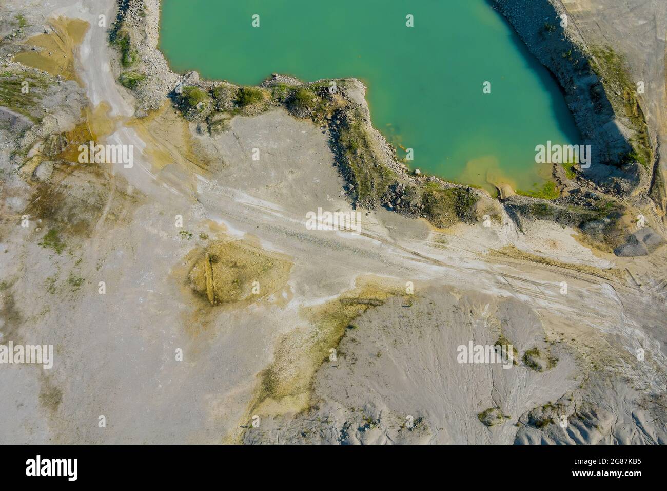 Aerial photo from a clay pit with a of huge green lake for sand ...