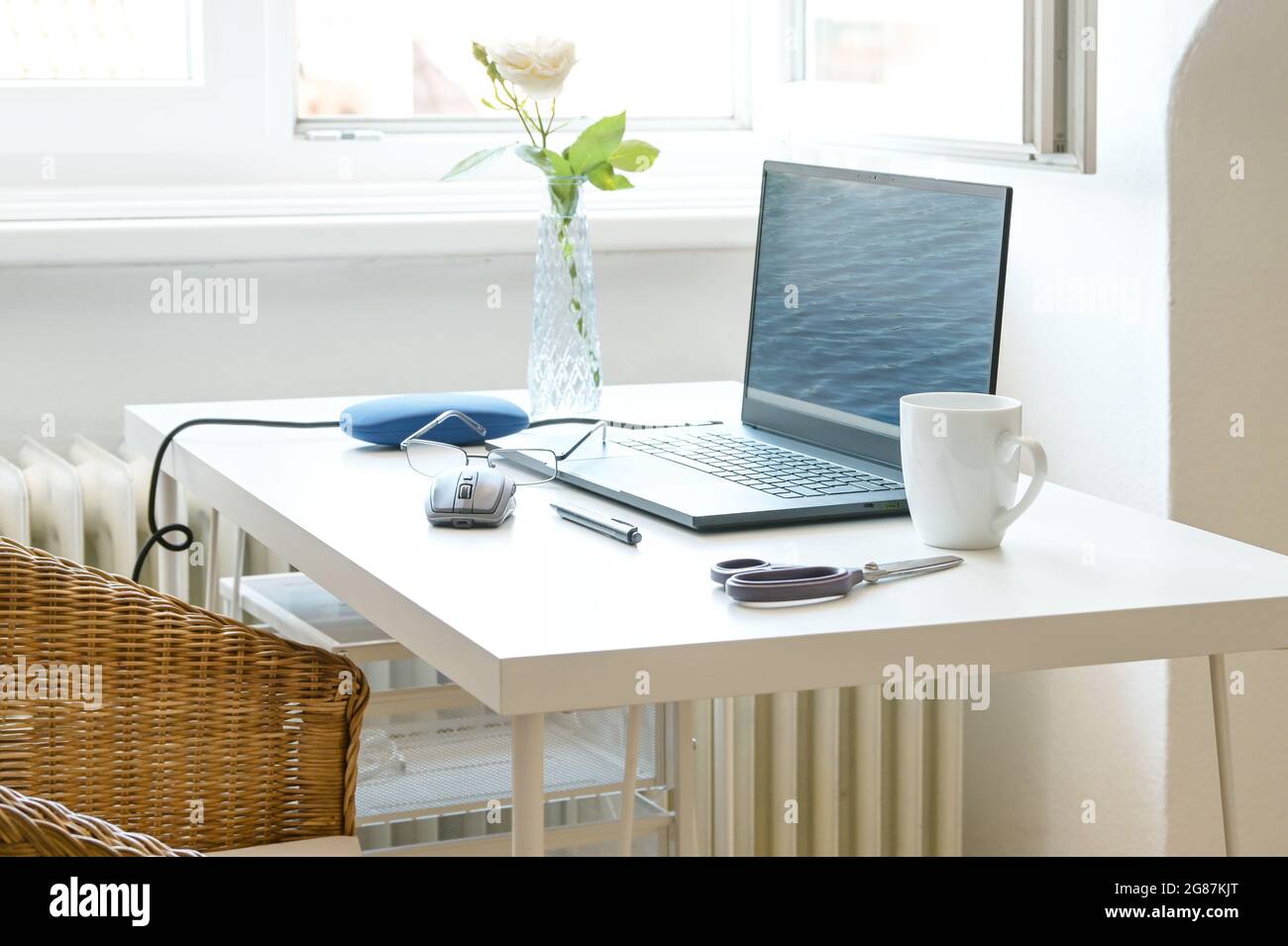Small white desk at the window with a laptop as a workspace for ...